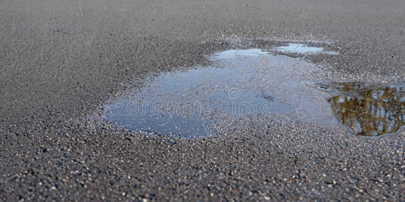 A Puddle on an Asphalt Road. the Water Left after the Rain. Stock Image ...