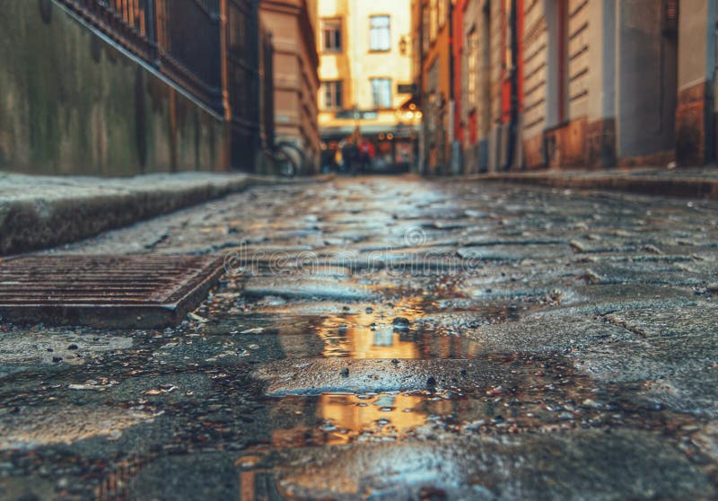 Puddle on Cobblestone Road in City Stock Image - Image of cobblestone ...