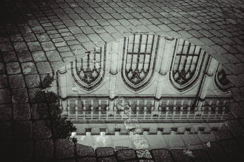 Puddle on the Cobblestone Street with the Reflection of an Antique ...