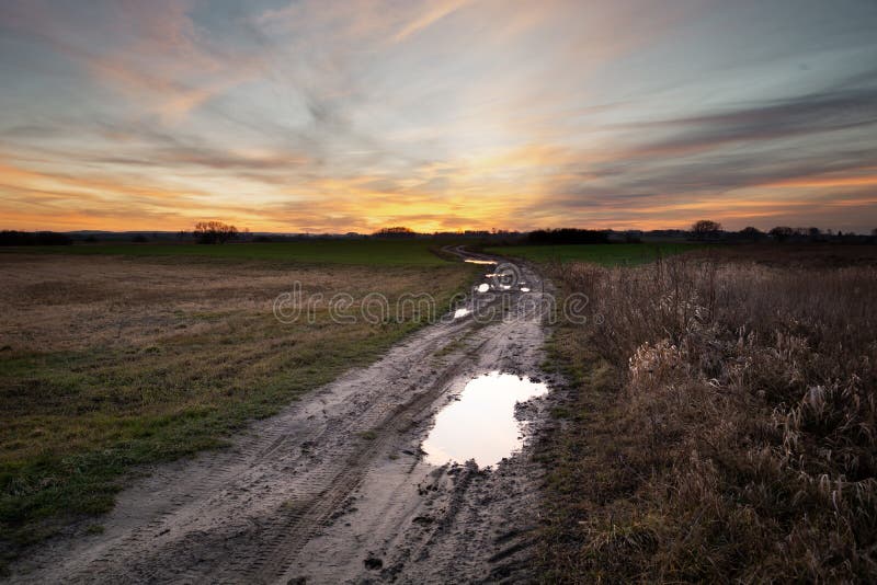 A Puddle on a Dirt Road and Sunset Clouds Stock Image - Image of rural ...