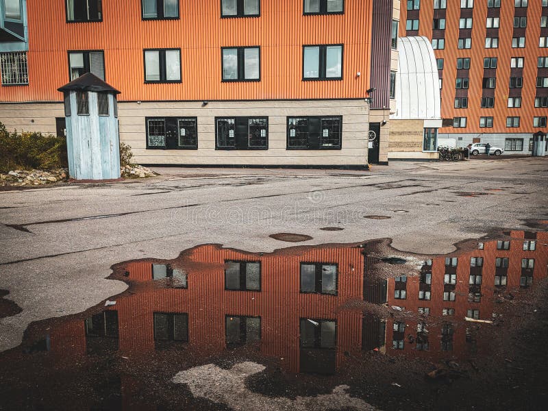 A Puddle in Front of Orange Building Stock Image - Image of outdoor ...
