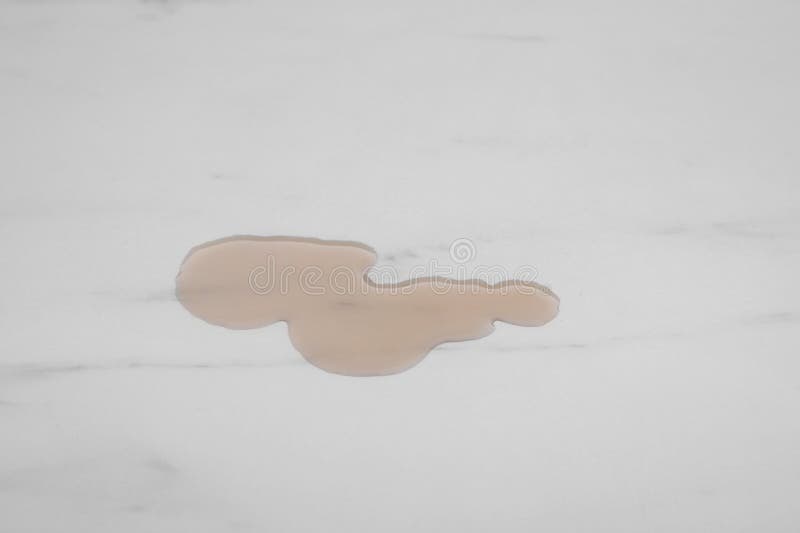 Puddle of Liquid on White Marble Table, Top View Stock Photo - Image of ...