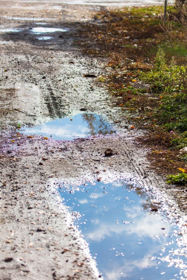 Puddle on a Muddy Road in Autumn Stock Image - Image of muddy, water ...