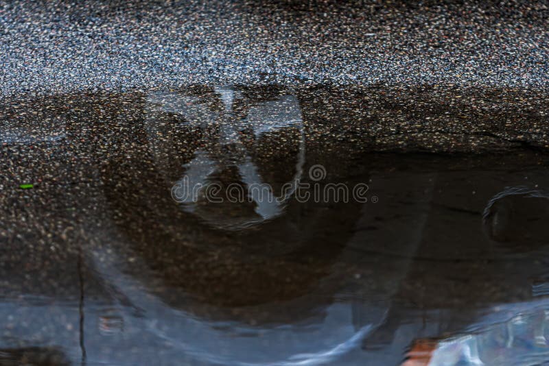 Puddle on the Pavement with a Reflection of the Car Wheel, Closeup ...