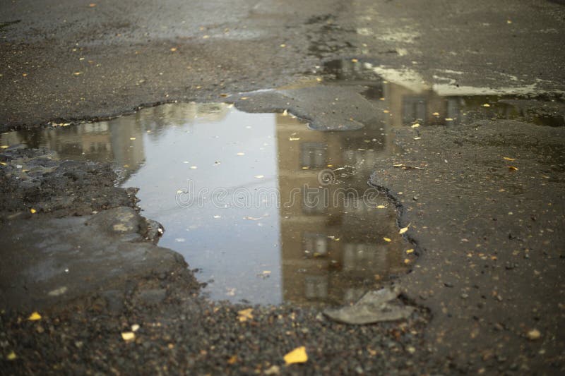 The Puddle on the Pavement. Wet Road Stock Image - Image of hole ...
