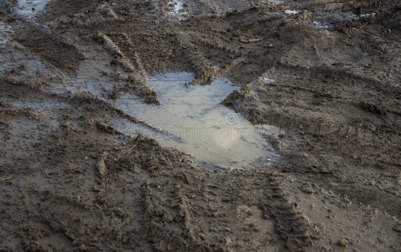 Puddle pit on dirty ground stock photo. Image of background - 144635368