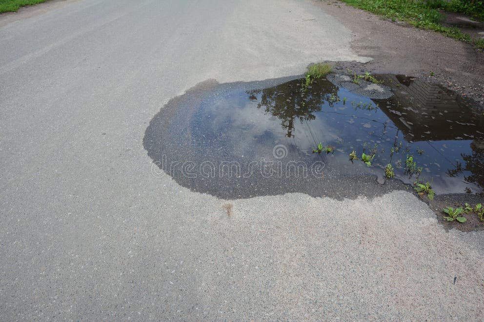 A Puddle on a Pothole in an Asphalt Road Stock Photo - Image of closeup ...