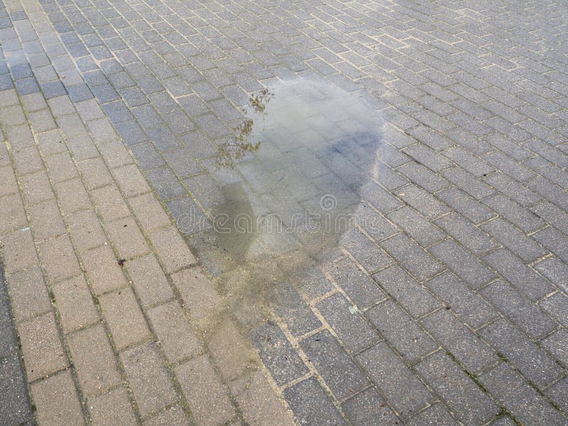 Puddle in a Pothole on a Road after a Rainstorm. Concept of Risk and ...