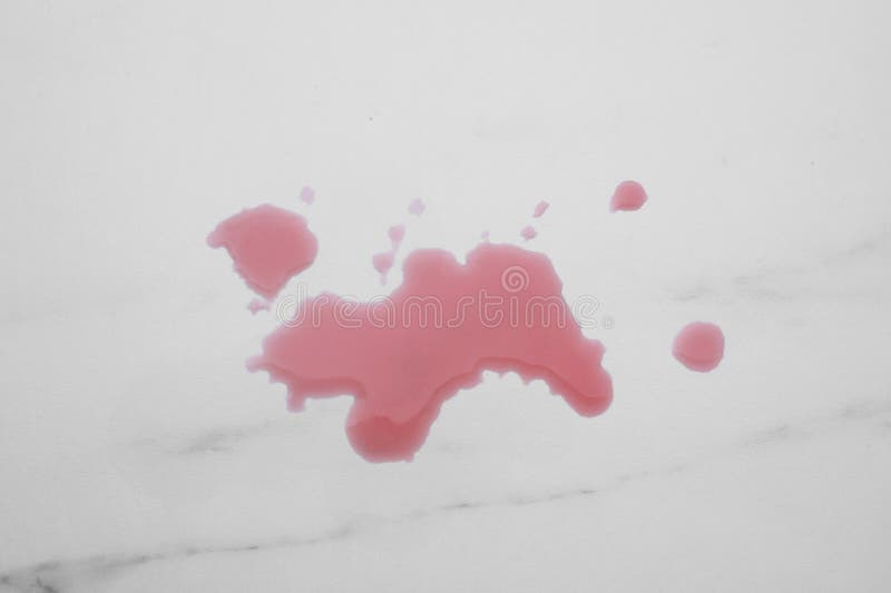 Puddle of Red Liquid on White Marble Surface, Top View Stock Photo ...