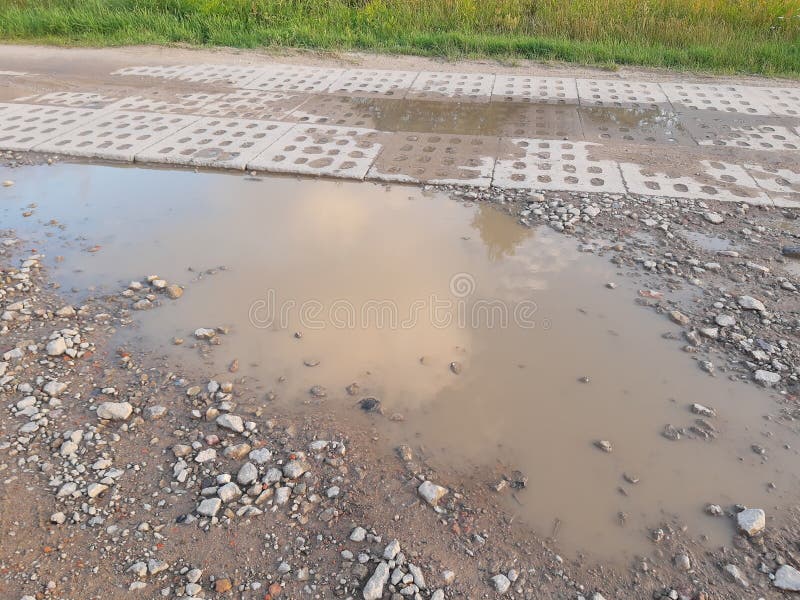 Puddle on the road stock photo. Image of pond, waterway - 284519164
