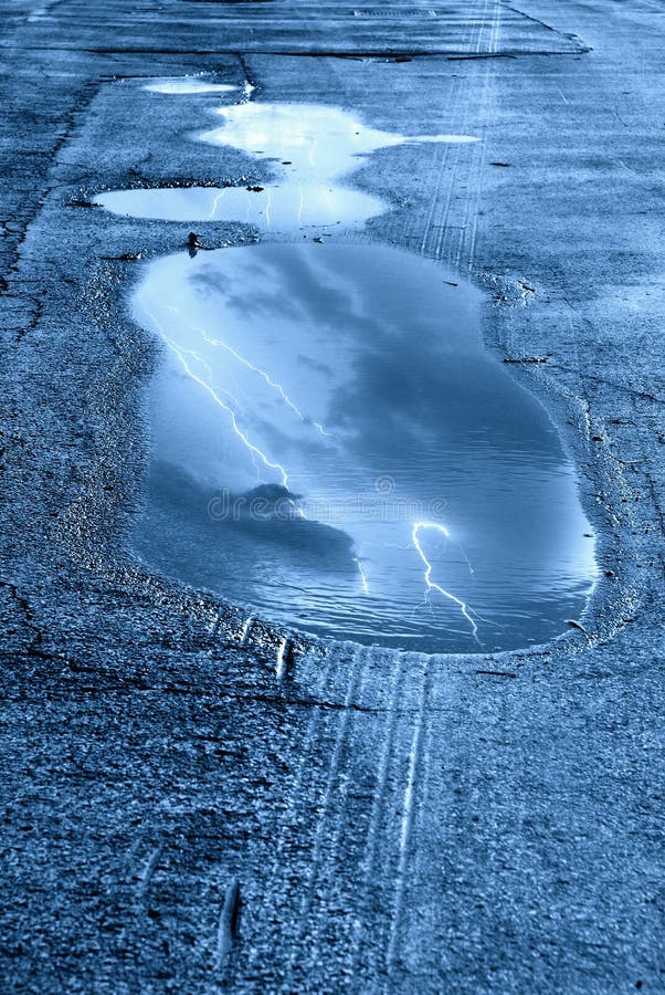 Puddle on the road stock photo. Image of light, asphalt - 33637160