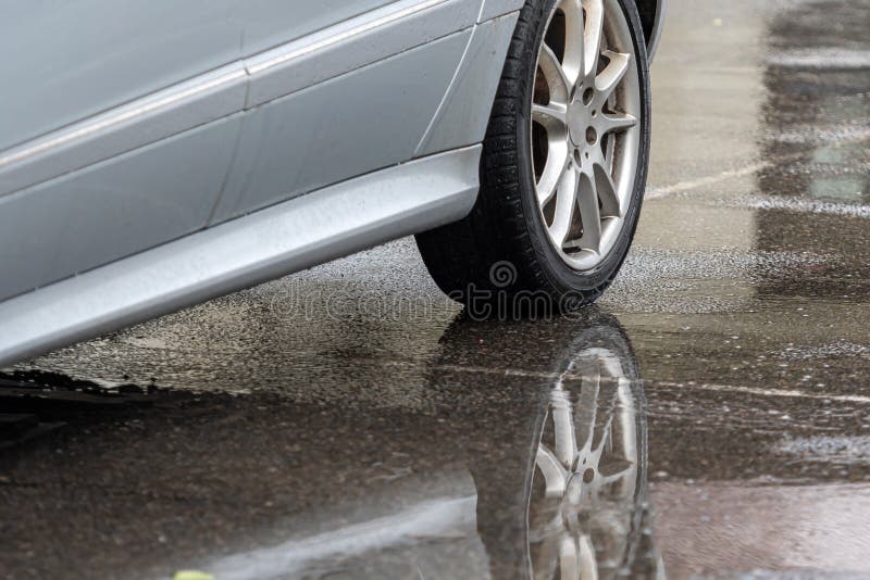 Puddle on the Sidewalk with a Reflection of a Parked Car, Closeup, Road ...