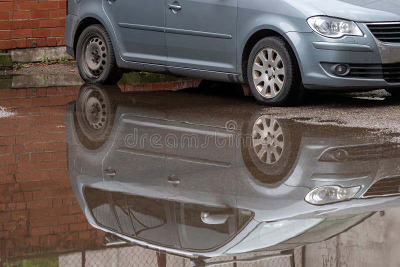 Puddle on the Sidewalk with a Reflection of a Parked Car, Closeup, Road ...