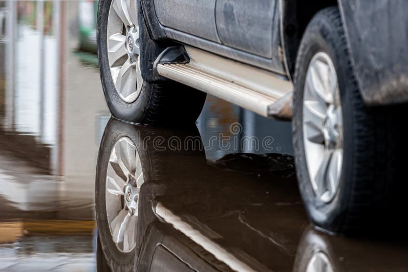 Puddle on the Sidewalk with a Reflection of a Parked Car, Closeup, Road ...