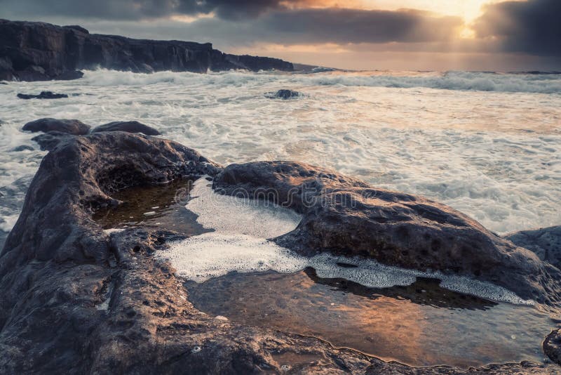 Puddle of Water with Foam on a Rough Stone by the Ocean. Dramatic Ocean ...