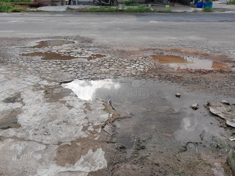 Puddle of Water in the Middle of the Asphalt Road. Stock Photo - Image ...