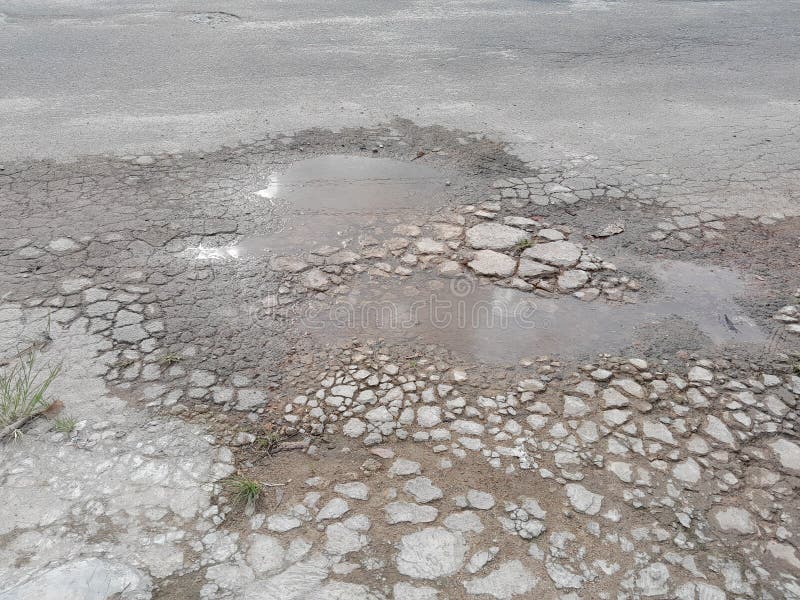 Puddle of Water in the Middle of the Asphalt Road. Stock Photo - Image ...