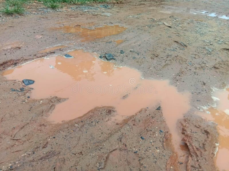 Puddle on red soil stock image. Image of land, dirt - 255501791