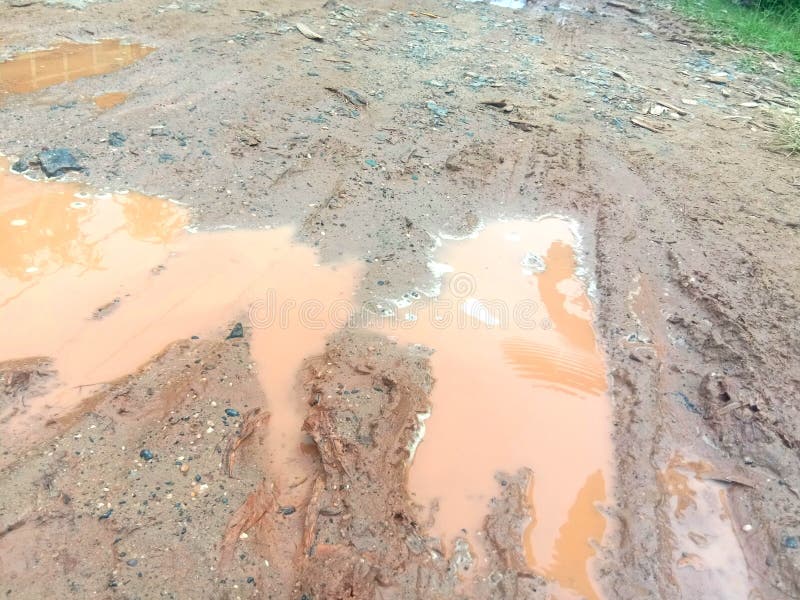 Puddle on red soil stock image. Image of brown, looks - 255501835
