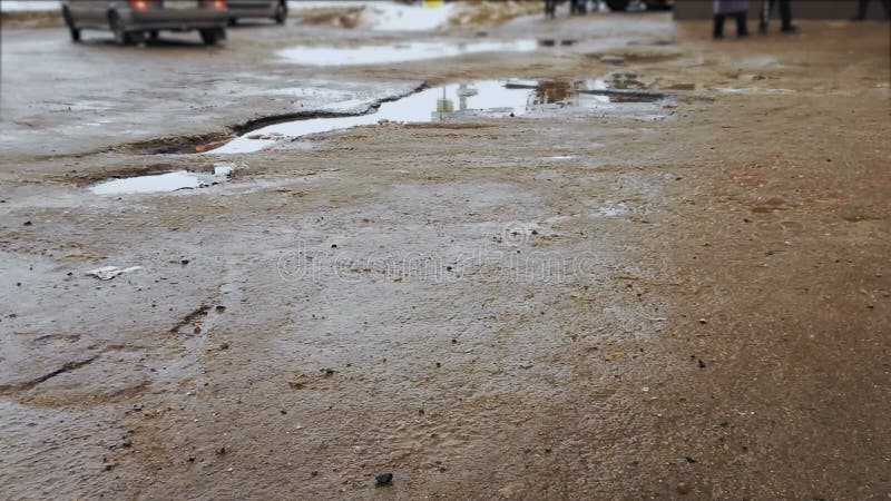 Puddles on the Road from the Ground Near the Asphalt Road with Cars ...