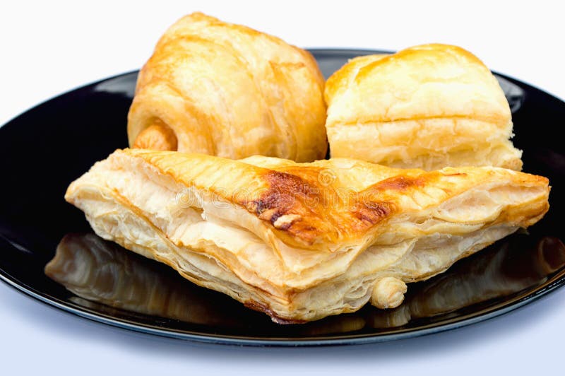 Puff on a Black Plate on Isolate White Background Stock Photo - Image ...