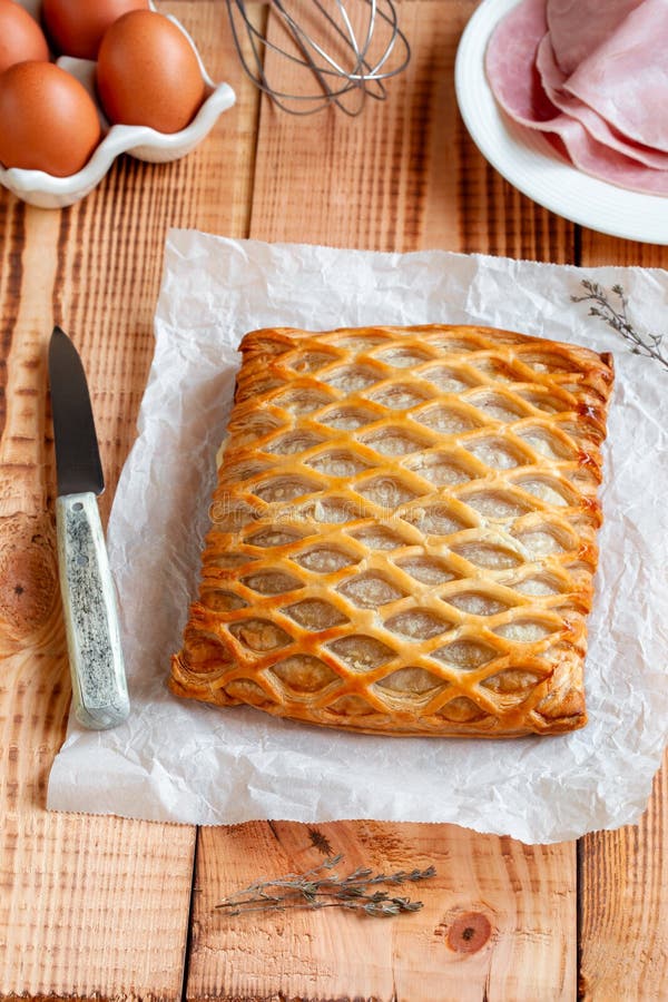 Puff with Ham and Cheese Cut on a Rectangular Plate on a Kitchen Table ...