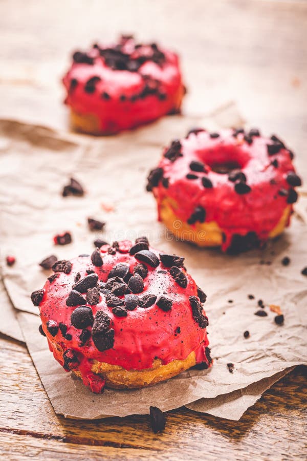 Puff Pastry Donuts with Pink Icing and Cookie Chips Stock Image - Image ...