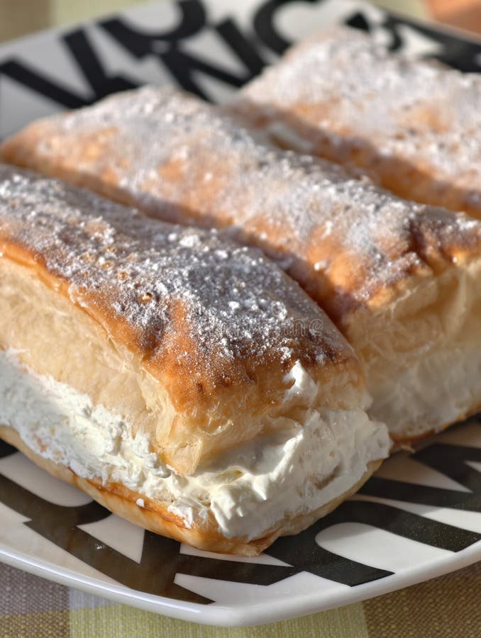 Puff Pastry Filled with Whipped Cream Served on a Black and White Plate ...