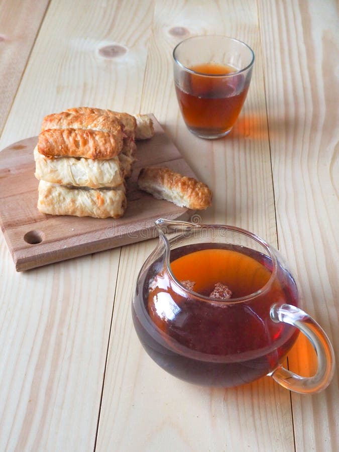 Tea with Biscuit Puff Rolls on a Wooden Table. Stock Image - Image of ...