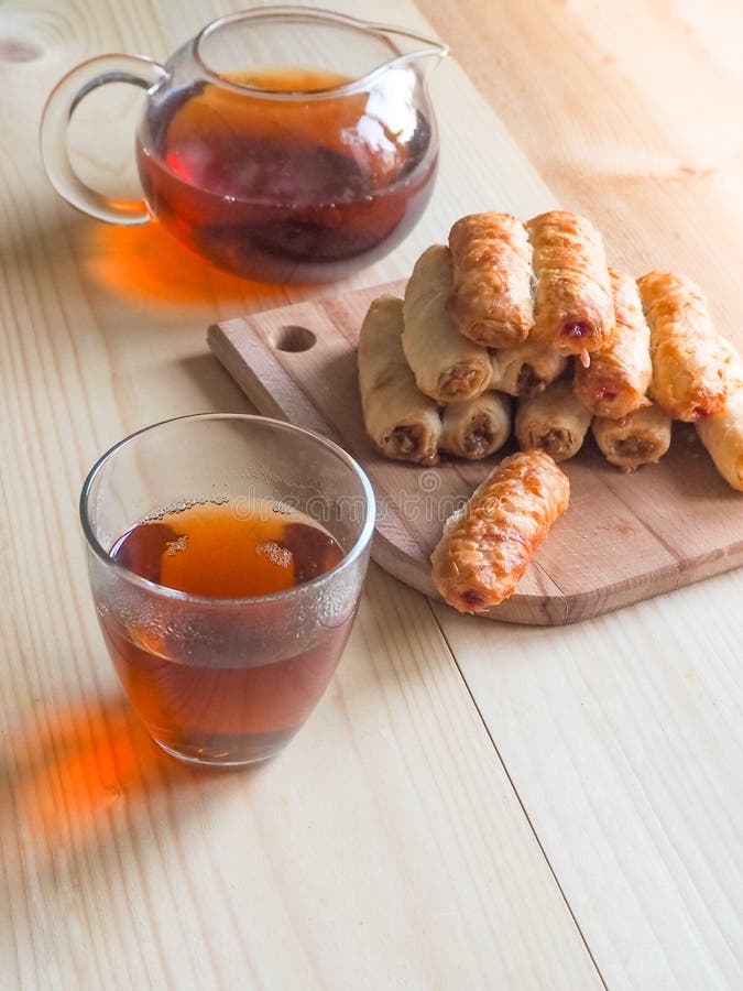 Tea with Biscuit Puff Rolls on a Wooden Table. Stock Photo - Image of ...