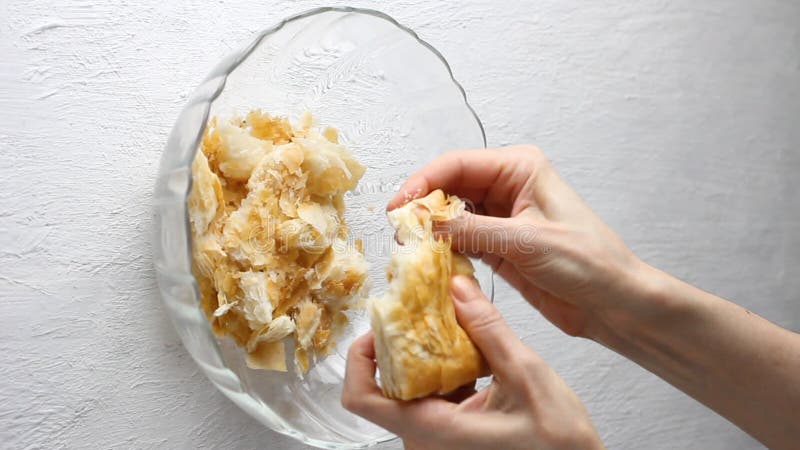 Puff Pastry is Torn into Pieces by Female Hands. Cooking Umm Ali ...