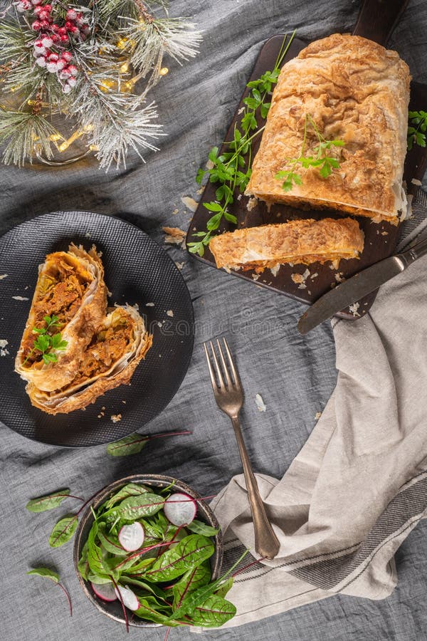 Puff Pastry Vegetable Roll on Kitchen Table with Christmas Decorated ...