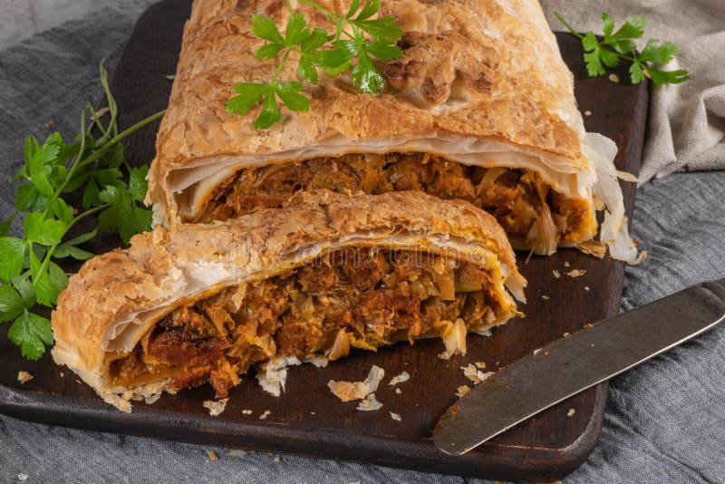 Puff Pastry Vegetable Roll on Kitchen Table with Christmas Decorated ...