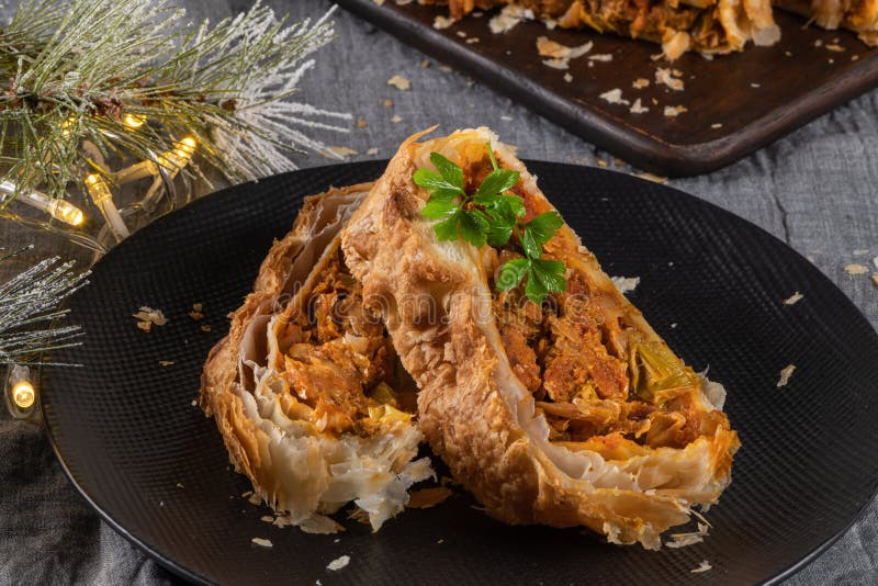 Puff Pastry Vegetable Roll on Kitchen Table with Christmas Decorated ...
