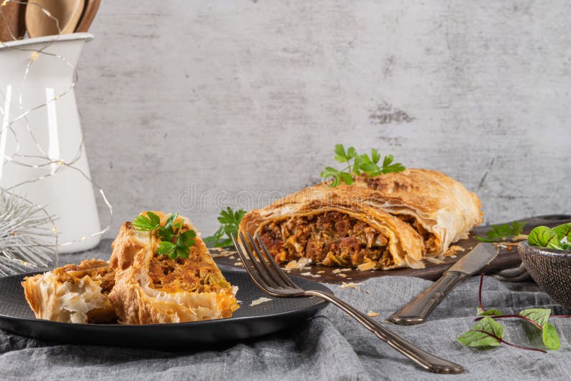 Puff Pastry Vegetable Roll on Kitchen Table with Christmas Decorated ...