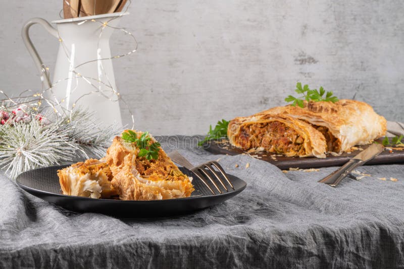 Puff Pastry Vegetable Roll on Kitchen Table with Christmas Decorated ...