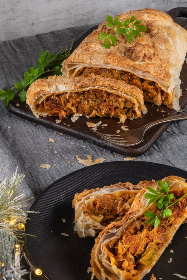 Puff Pastry Vegetable Roll on Kitchen Table with Christmas Decorated ...
