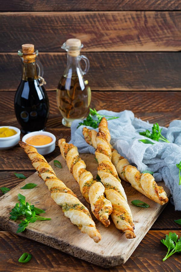 Puff Sticks with Cheese and Herbs. Homemade Breadsticks with Sauce ...