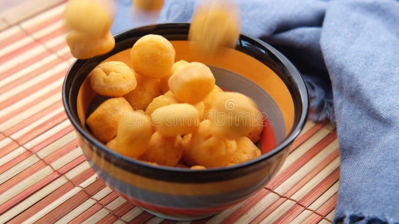 Puffed Corn Rings Chips Falling in a Bowl on Table Stock Video - Video ...