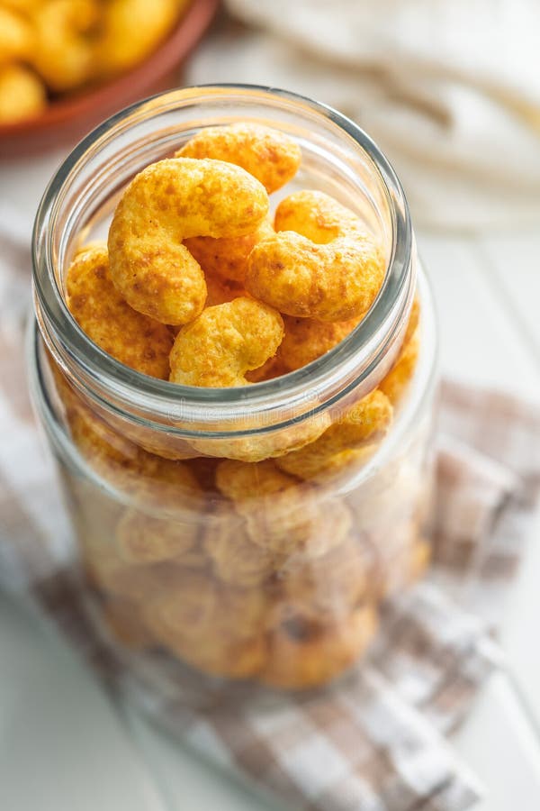 Puffed Crispy Peanut Flips in Jar on White Table Stock Image - Image of ...