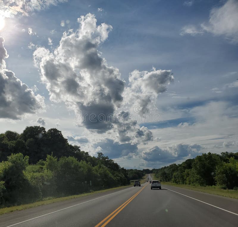 Puffy Clouds on the Highway Stock Photo - Image of trees, highway ...