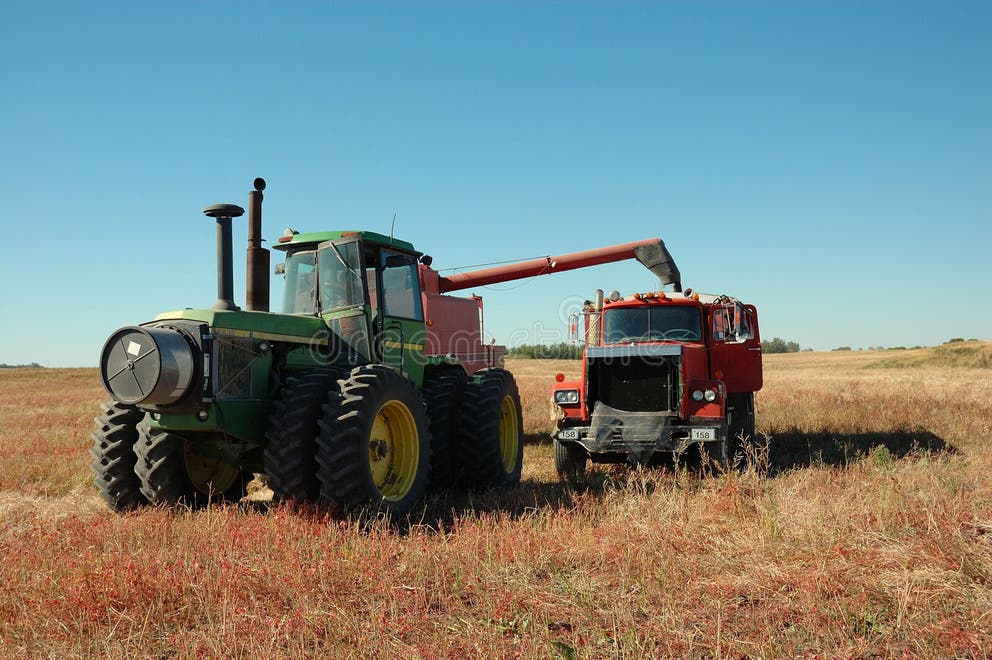 Pull Combine Dumping into Grain Truck Stock Photo - Image of farm, dump ...