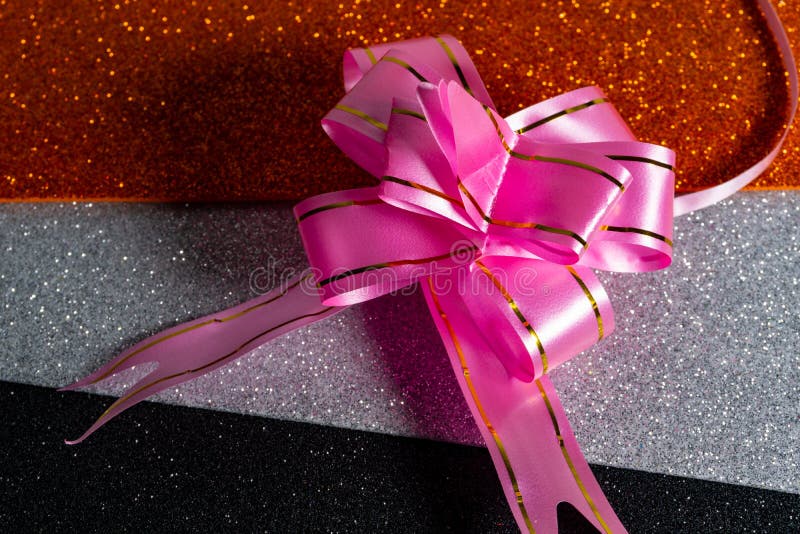 Pull Flower Ribbon for Gift Wrap on Glitter Background Lighting Effect ...