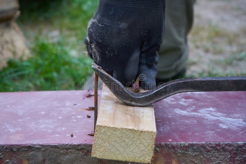 Pull Out Crowbar Nails, a Nail Puller Pulls a Nail Out of the Board ...