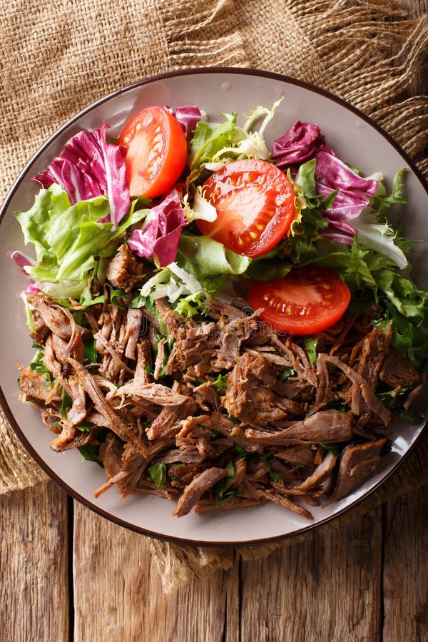 Pulled Spicy Beef with Fresh Vegetables Close-up on a Table. Vertical ...