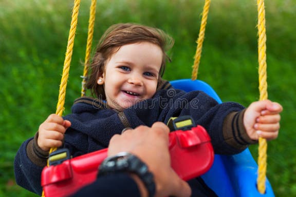 Pulling baby in swing stock photo. Image of lush, carefree - 40893308