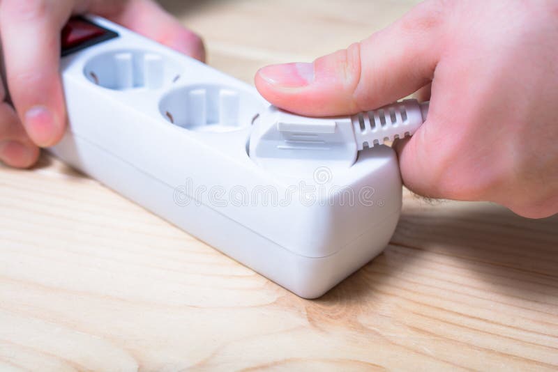 Pulling an Electrical Plug Out of a Power Strip To Save Energy - Power ...