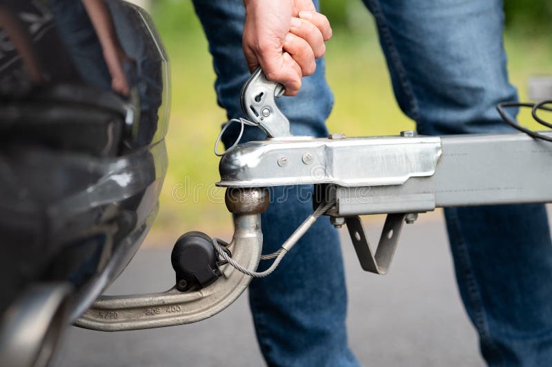 Pulling the Lever of the Hitch Coupling To Connect the Trailer Stock ...