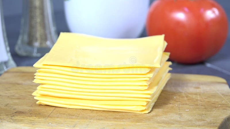 Slices of Cheddar Cheese Vanishing from a Stack on a Cutting Board ...
