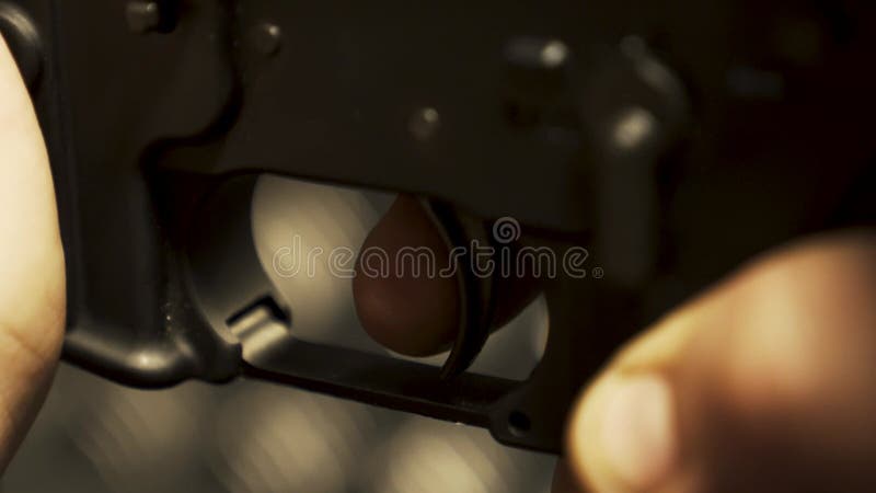 Pulling the Trigger on a Machine Gun Close-up of a Hand-held Firearm ...